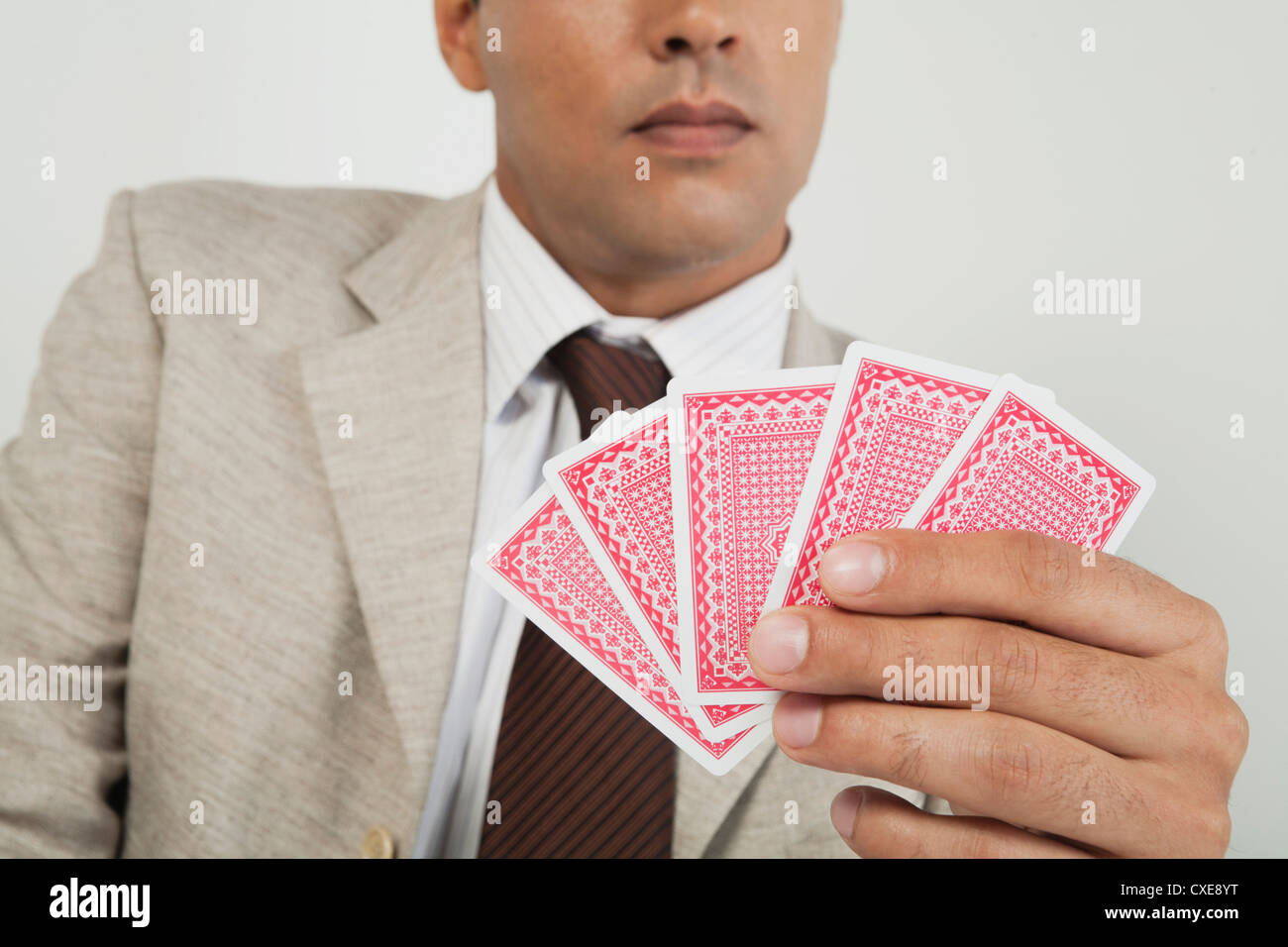 Man playing card game, cropped Stock Photo - Alamy