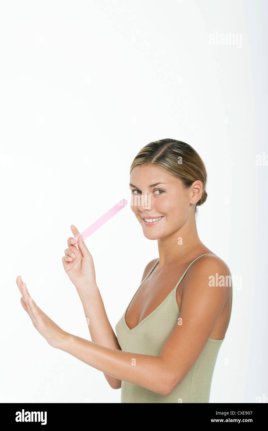 Young woman filing fingernails hi-res stock photography and images - Alamy