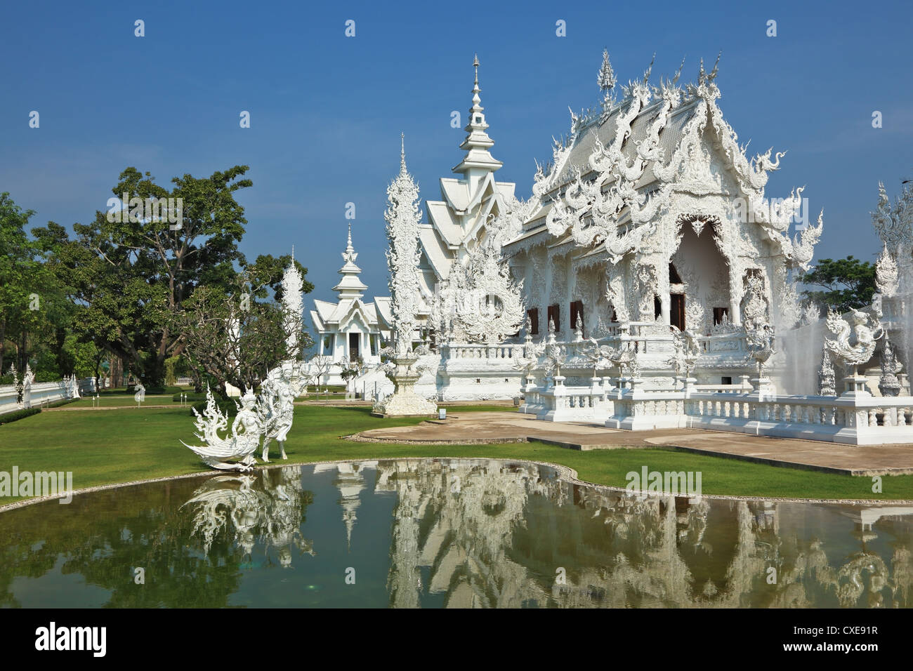Castle reflected in a pond with live fish Stock Photo - Alamy