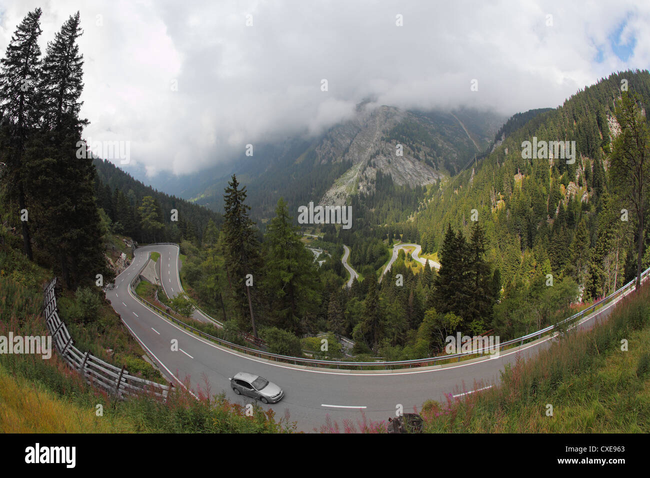 Cars on a steep bend in the road Stock Photo - Alamy