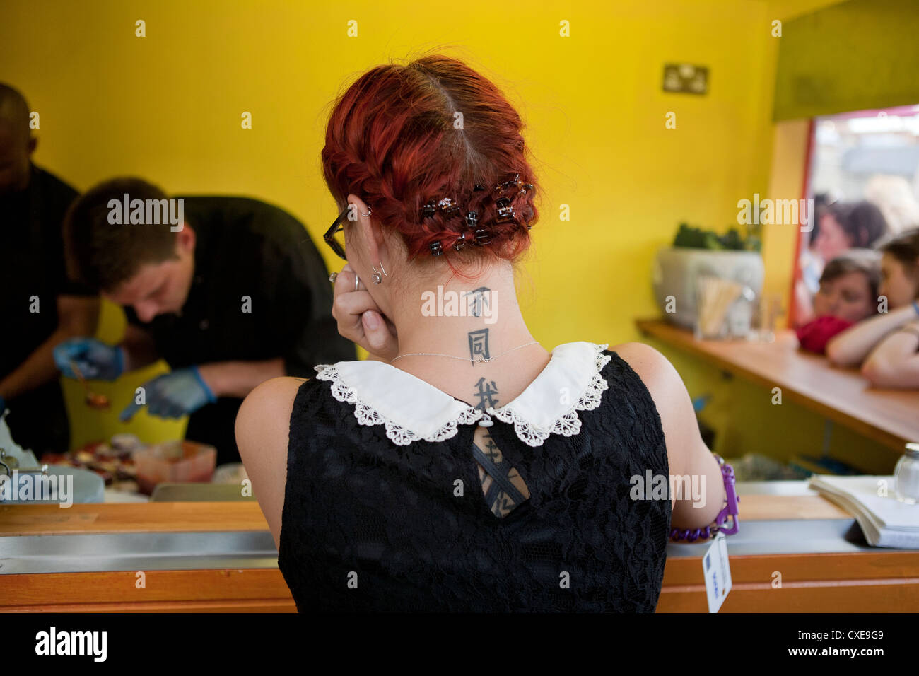London, 22/08/2012, Waitress with tattoo on the neck is waiting to ...