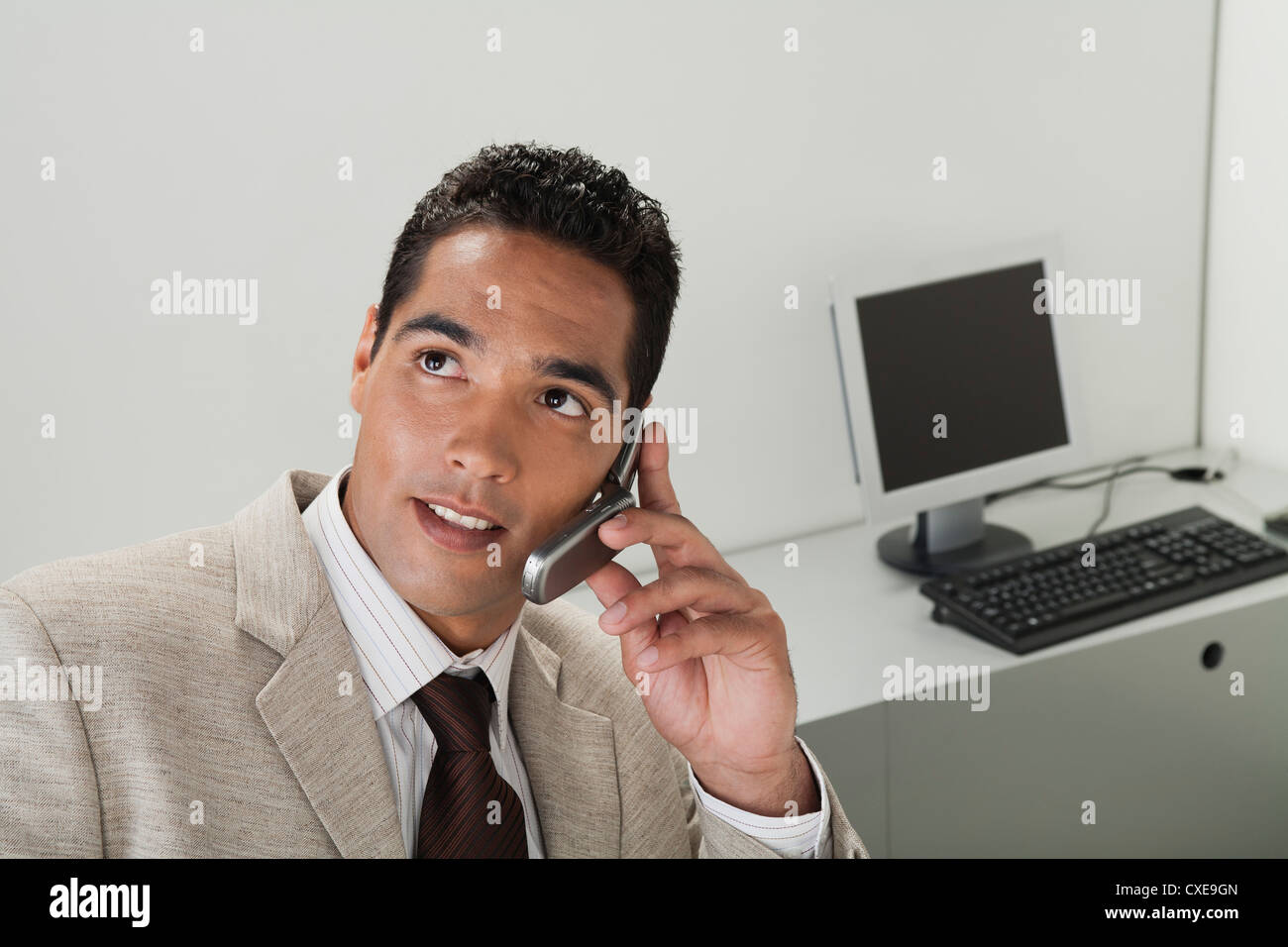 Businessman using cell phone in office Stock Photo - Alamy
