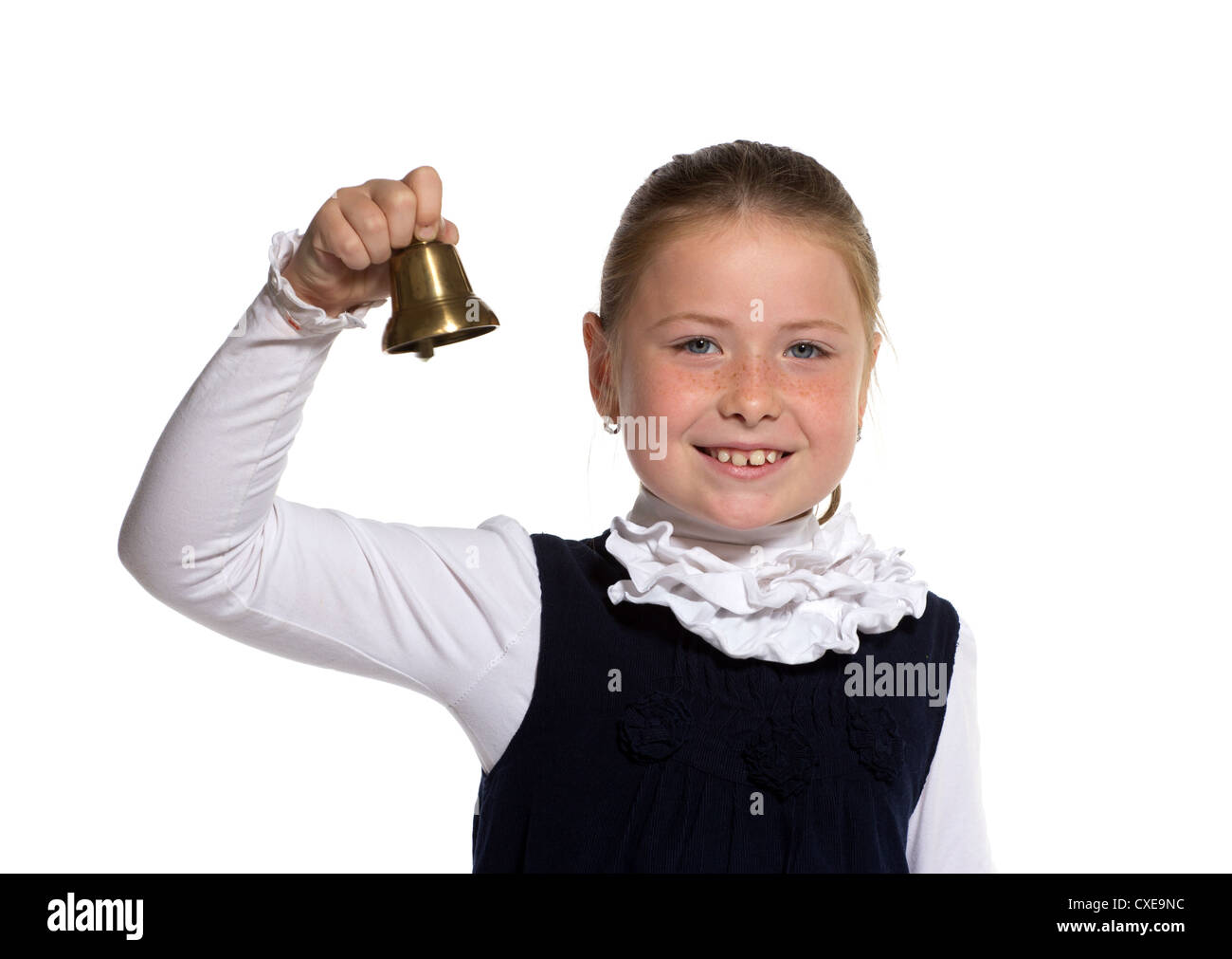 Young school girl ringing a golden bell on white background Stock Photo ...