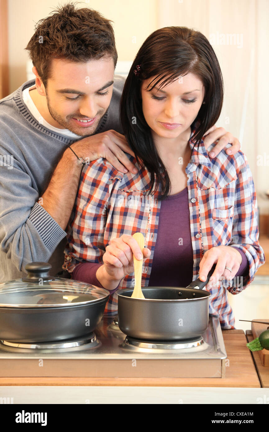 Young married couple cooking dinner Stock Photo - Alamy
