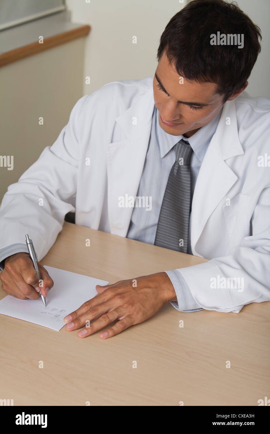 Doctor writing prescription Stock Photo - Alamy