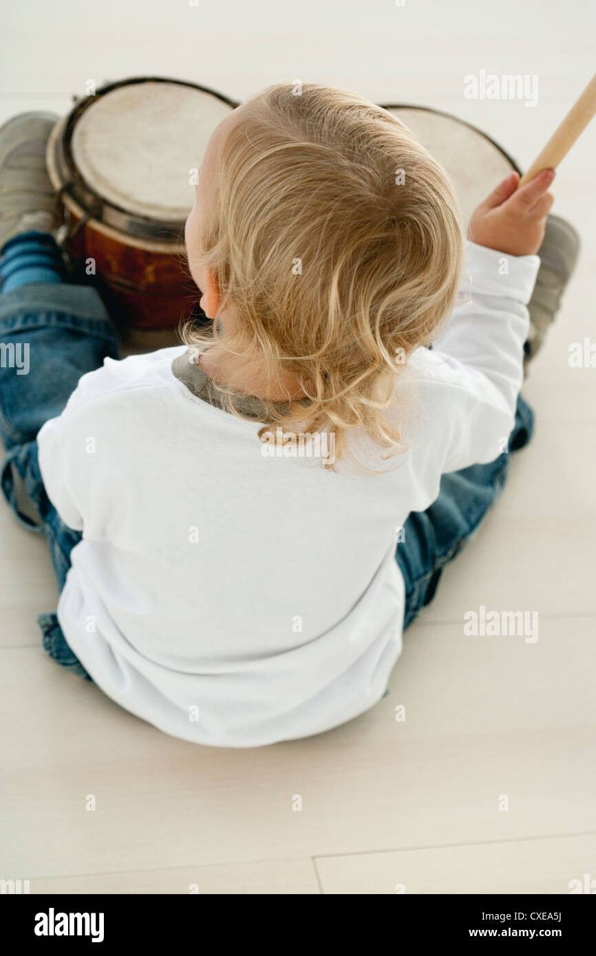 Baby boy playing drums, rear view Stock Photo - Alamy