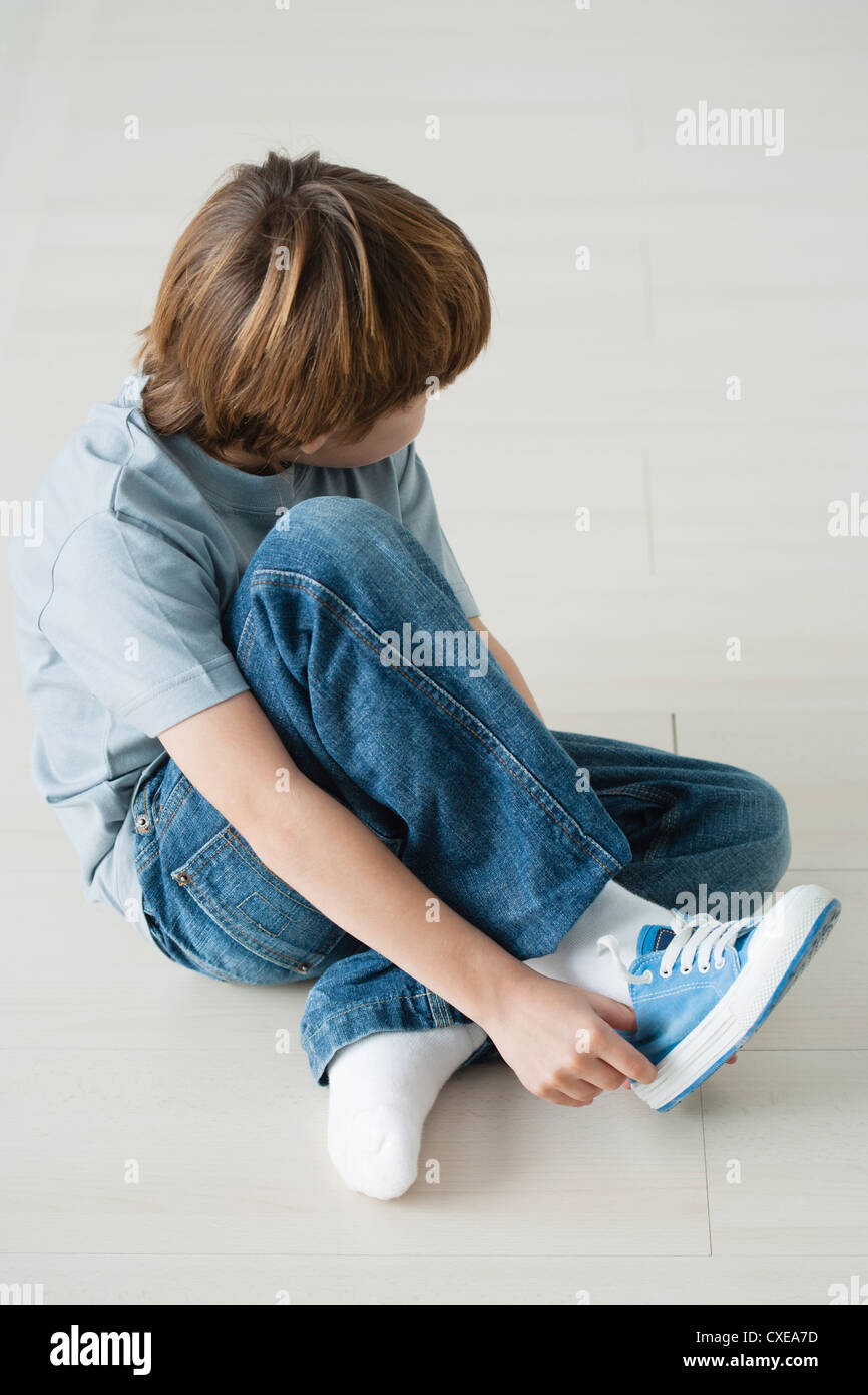 Boy Putting On Shoes