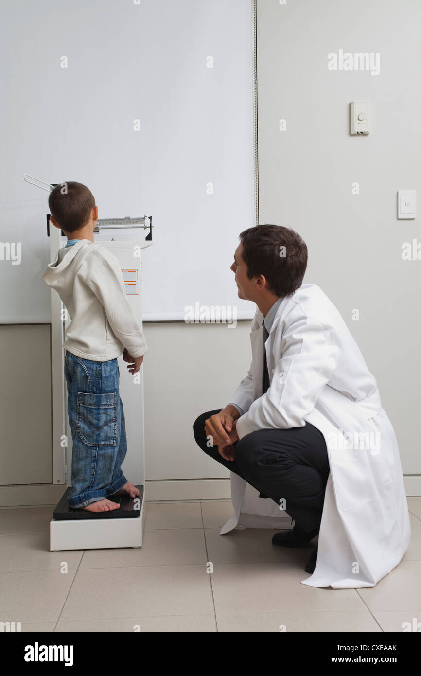 Little Boy Standing On Weight Scale In Doctor s Office Stock Photo Alamy
