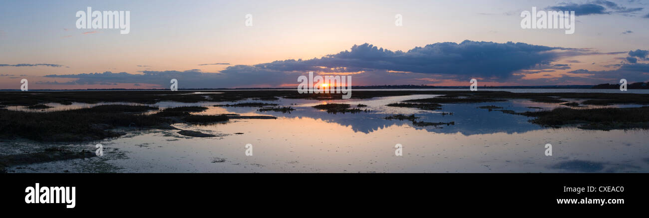 Sunset over marshes of Chichester Harbour on a very still evening, West ...