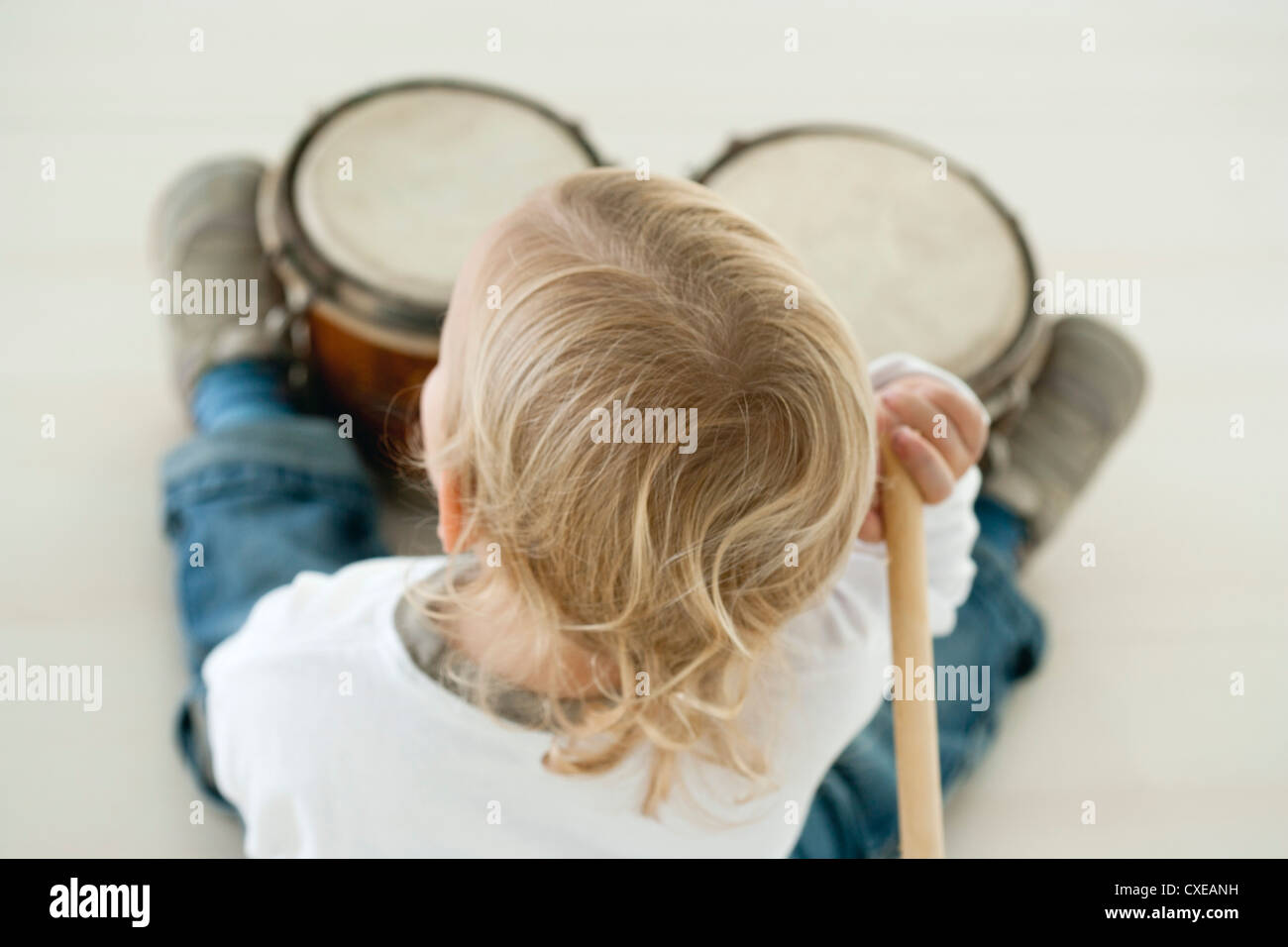 Baby boy playing drums, rear view Stock Photo - Alamy