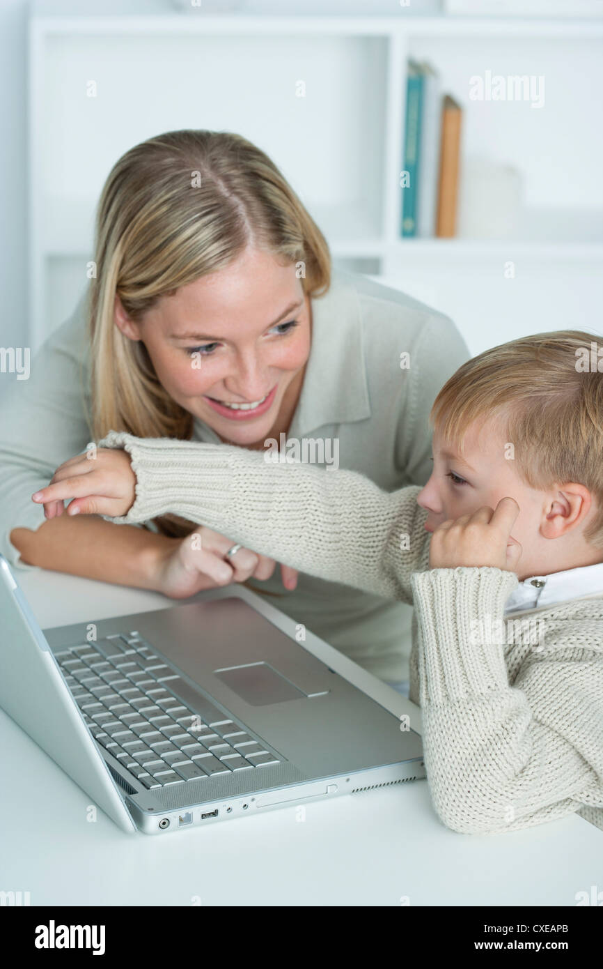 Mother and son using laptop computer together Stock Photo - Alamy