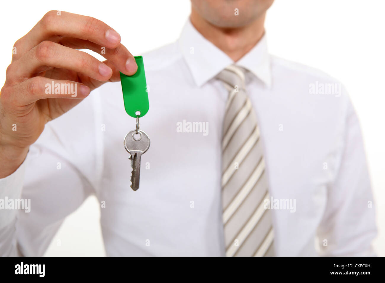 Businessman giving key Stock Photo - Alamy