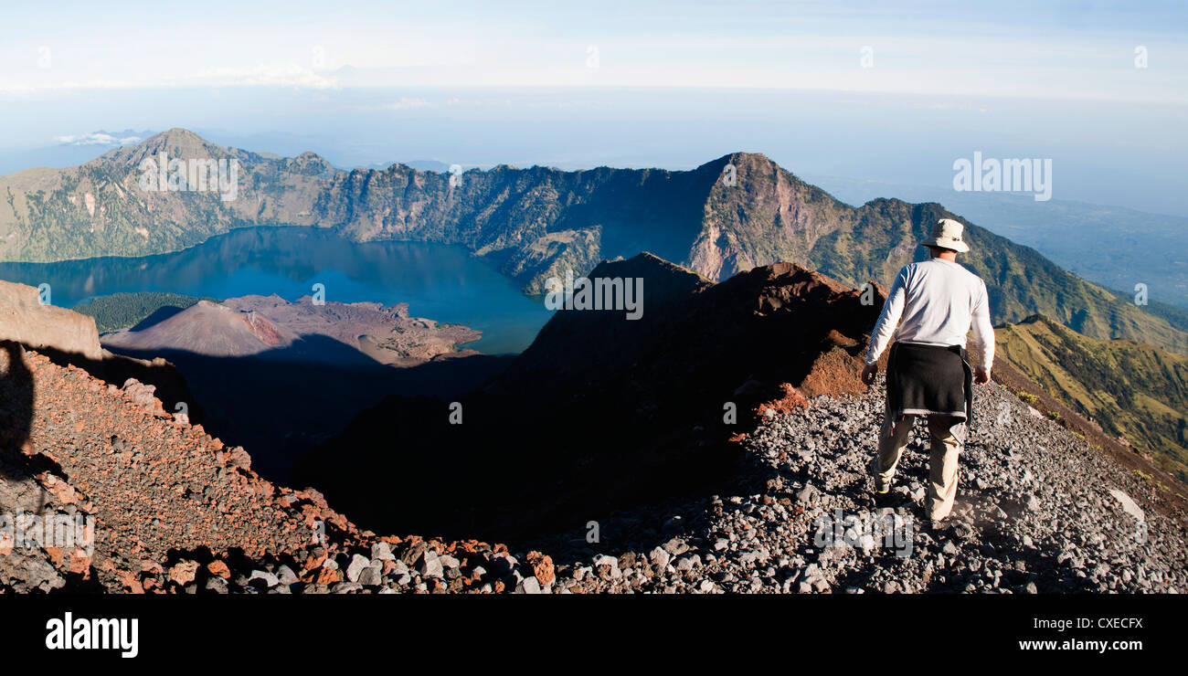 Tourist walking around the crater rim at the 3726m summit of Mount ...