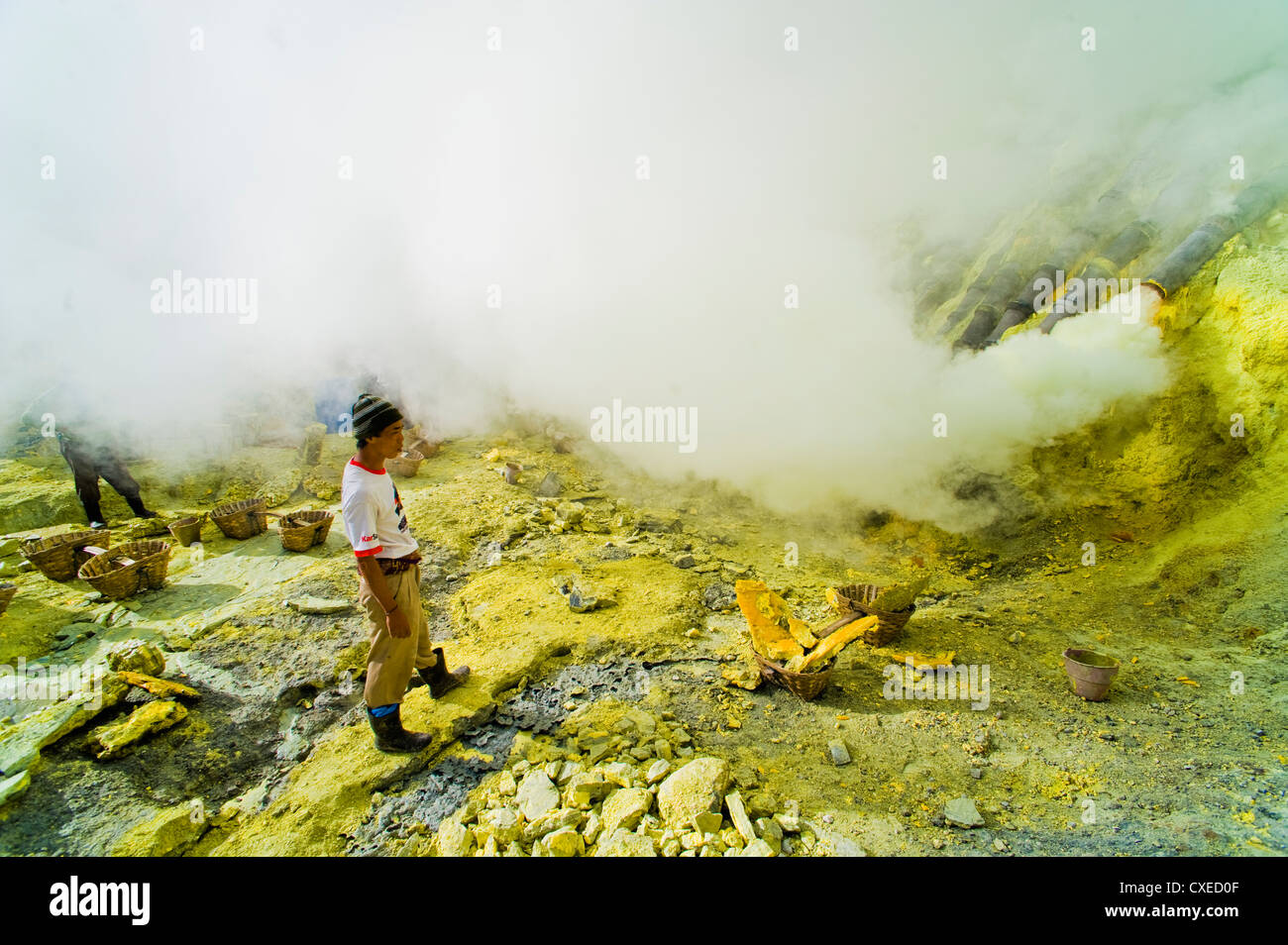 Sulphur miner working to mine sulphur at Kawah Ijen, Java, Indonesia ...