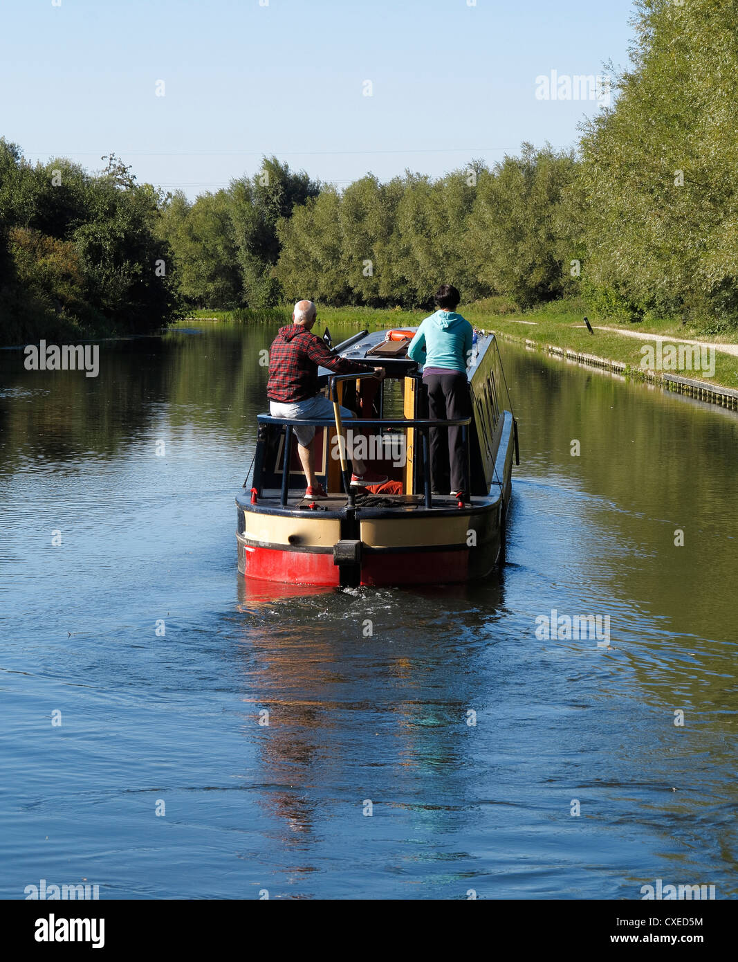 Narrow boat heading along river Cam Stock Photo - Alamy