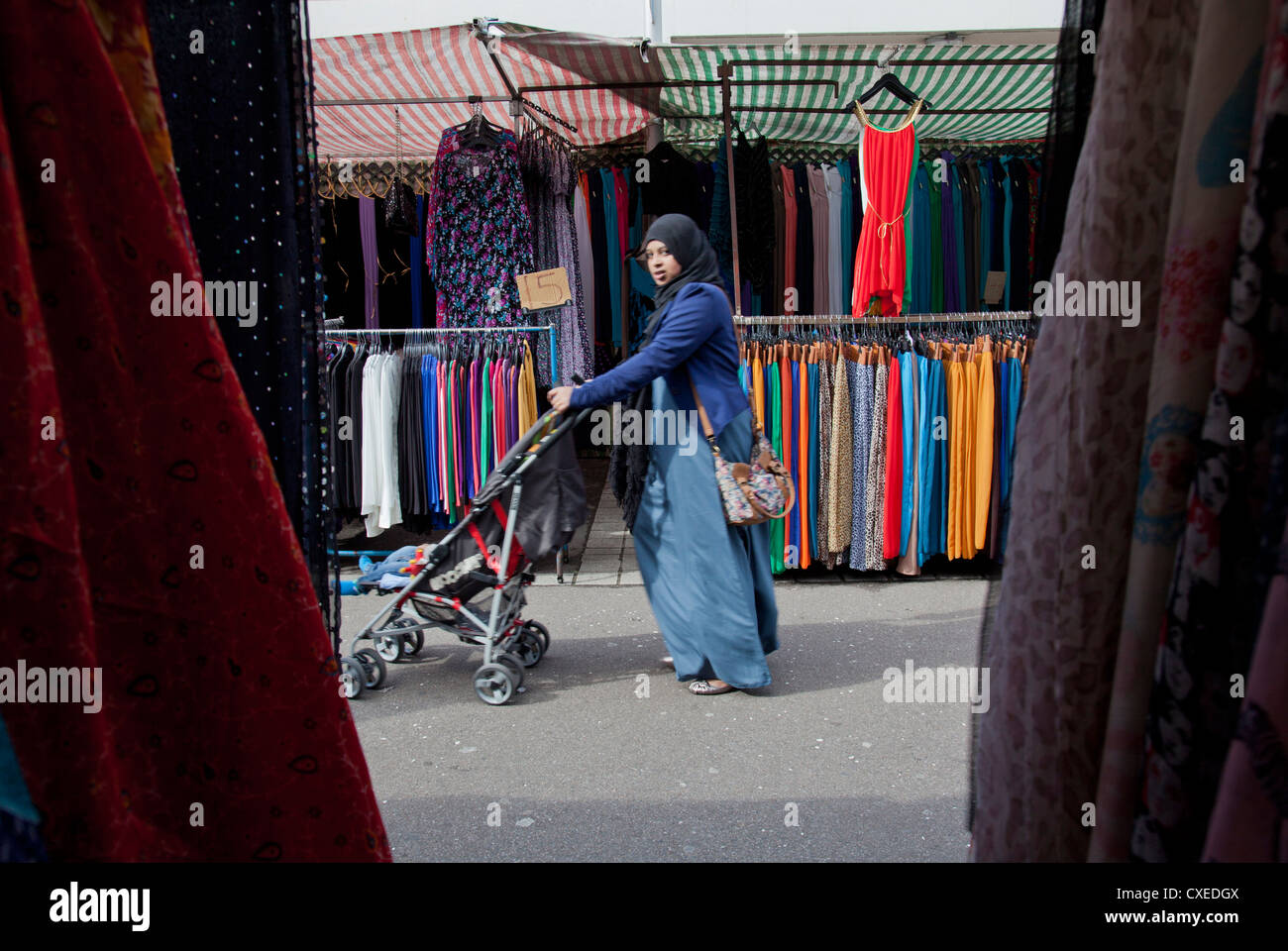 MUSLIM WOMAN WITH CHILD IN PRAM SHOPPING IN WATNEY STREET MARKET IN ...