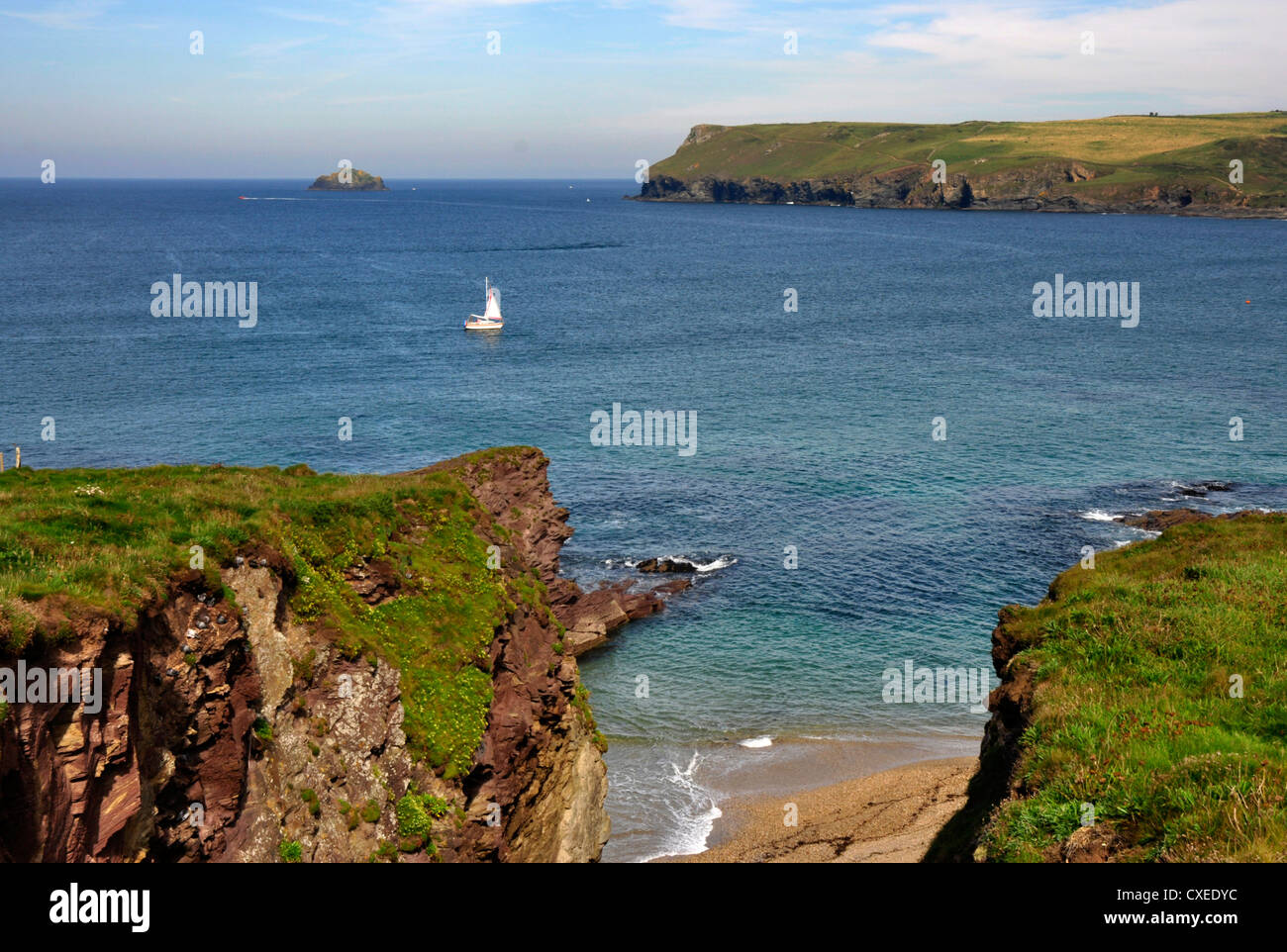 North Cornwall Coast path - near Polzeath - white sail on azure blue ...