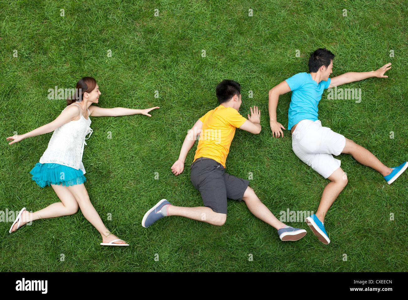 young people playing chase game on grass Stock Photo - Alamy