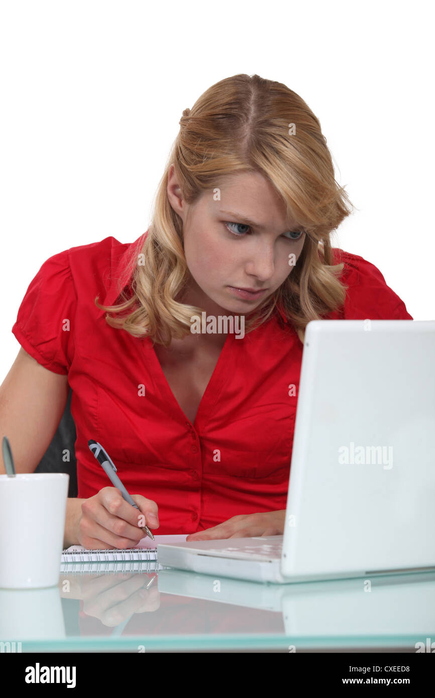 Woman writing notes from laptop Stock Photo - Alamy
