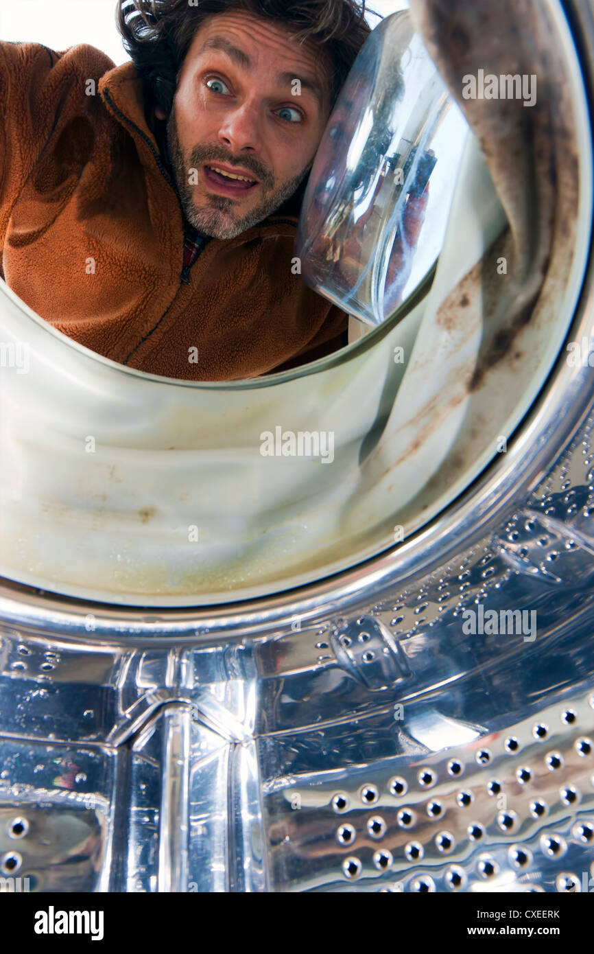 surprised man and inside view of a washing machine Stock Photo - Alamy