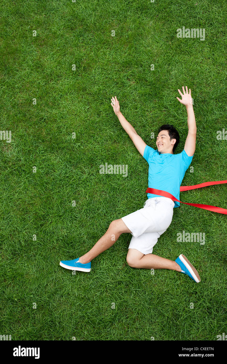 Creative young man imitating running attack on grass Stock Photo - Alamy