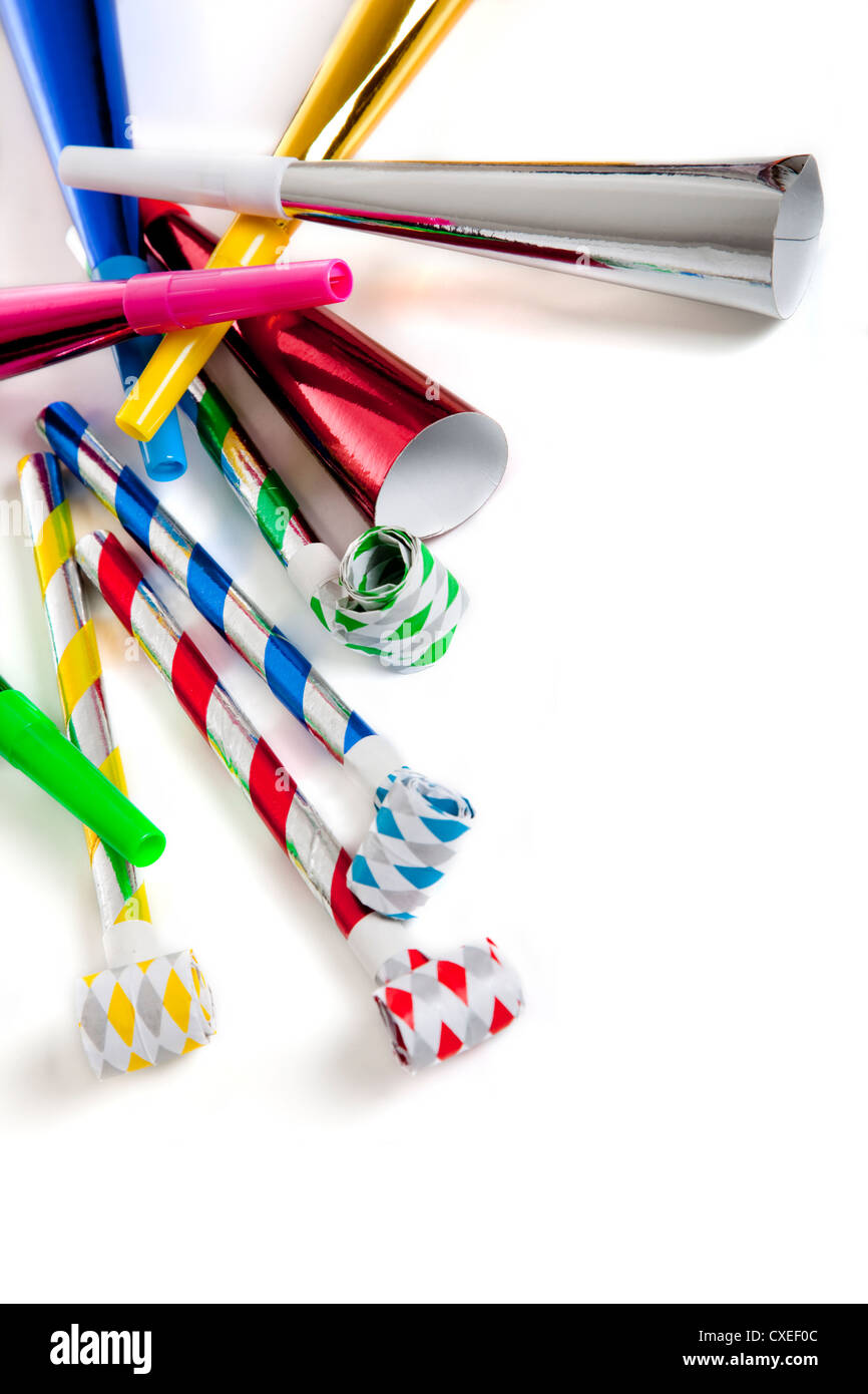 A group of colorful party noise makers, including horns etc. , on a ...