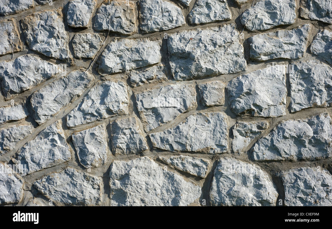 A masonry stone or brick wall background Stock Photo - Alamy