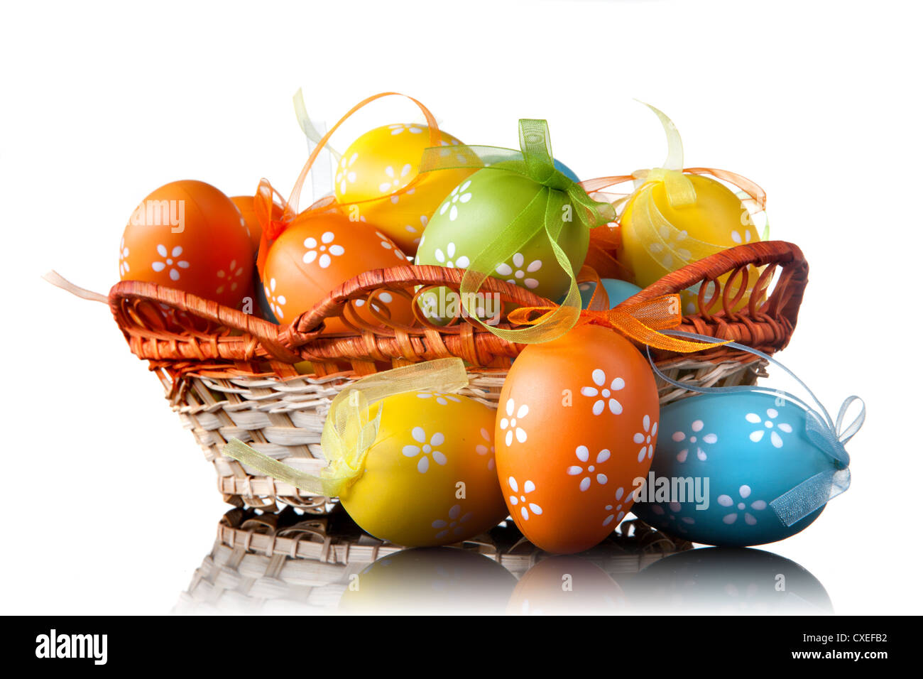 color easter eggs in basket isolated on white Stock Photo - Alamy