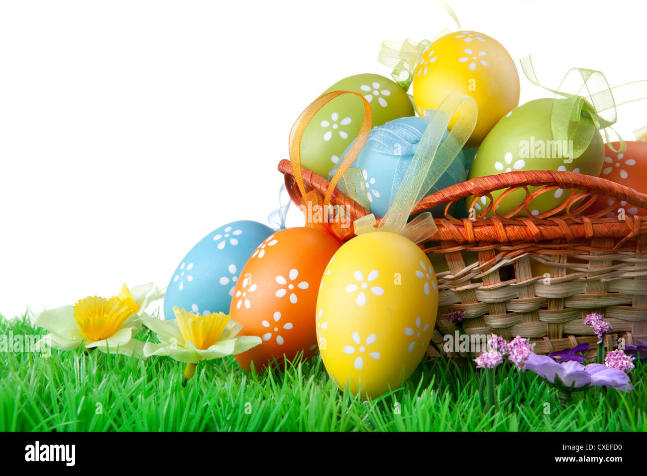 color easter eggs with green grass on the white Stock Photo - Alamy