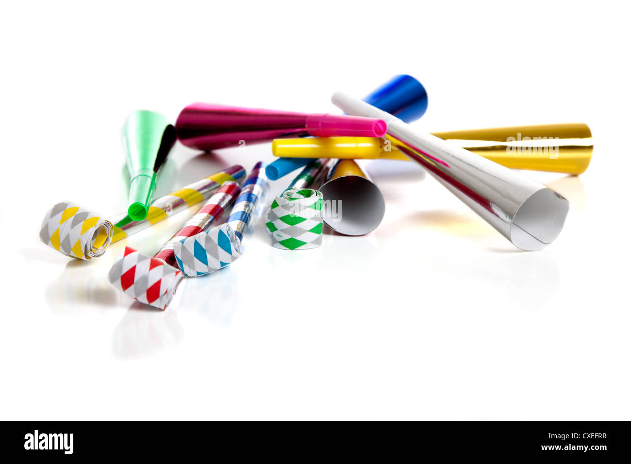 A group of colorful party noise makers, including horns etc. , on a ...