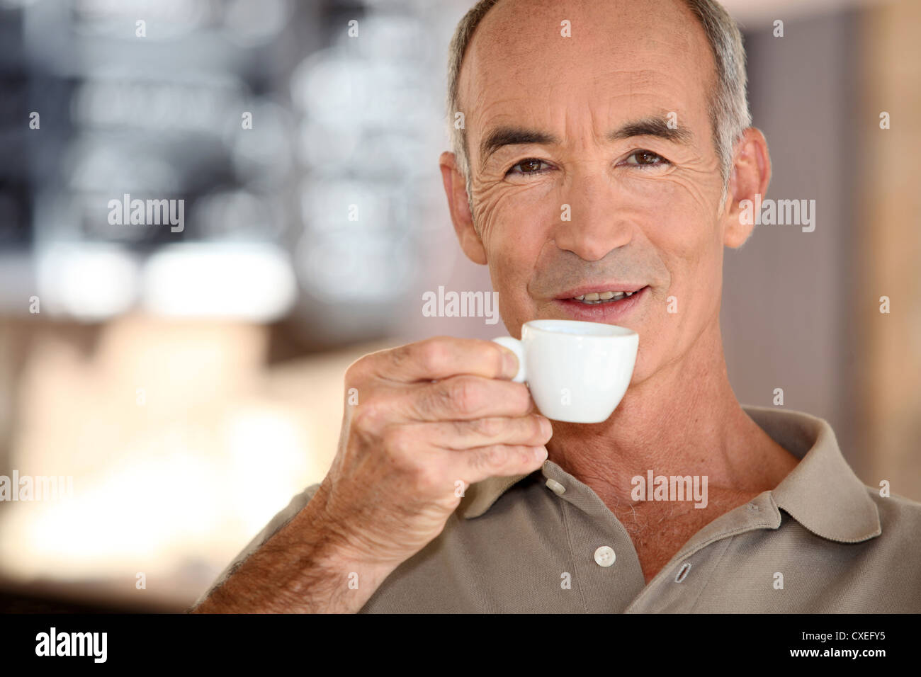 Elderly man drinking coffee Stock Photo - Alamy