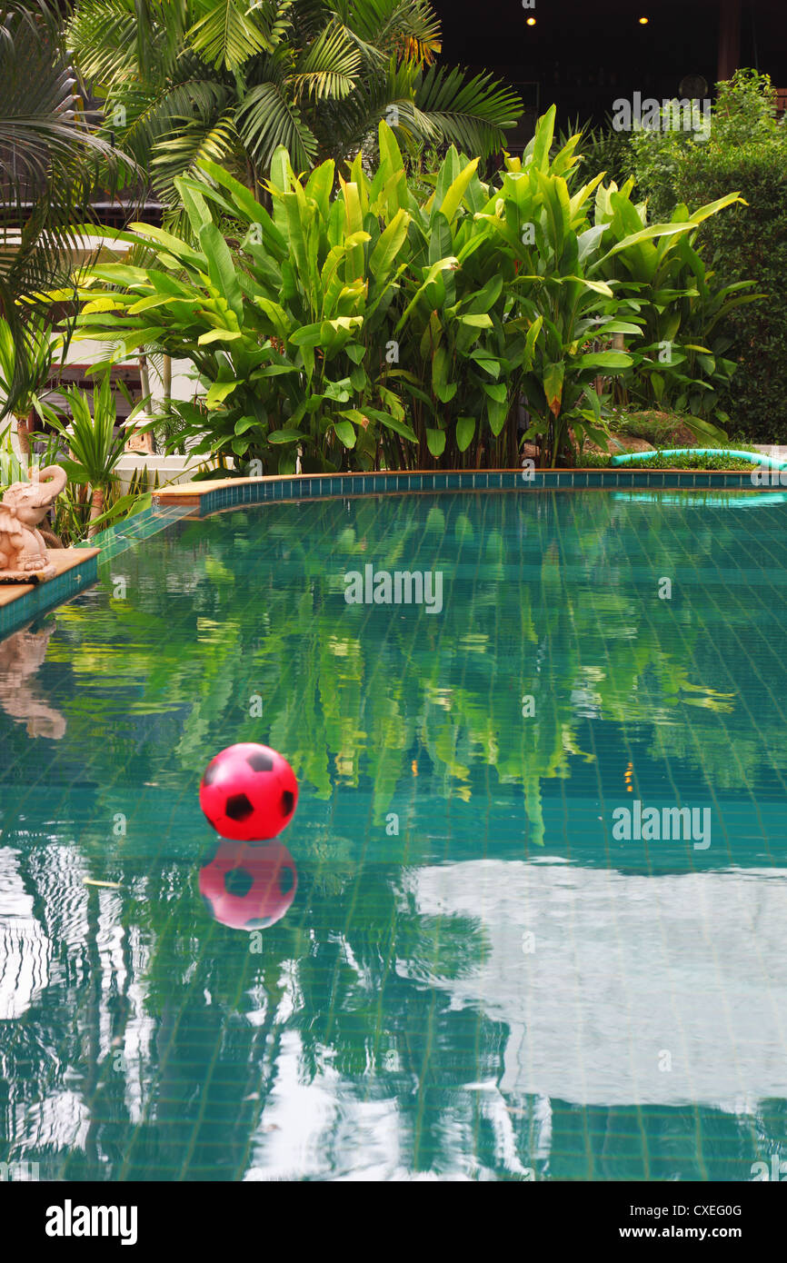 Red beach ball floating in pool Stock Photo - Alamy
