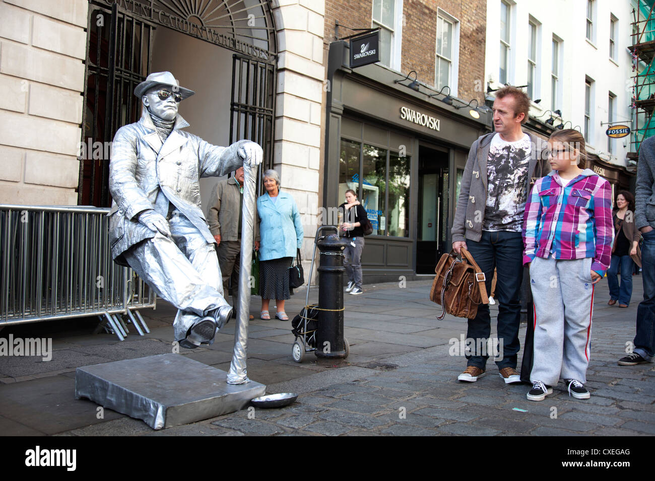 Statue street performer sits totally still as if floating in mid air in ...
