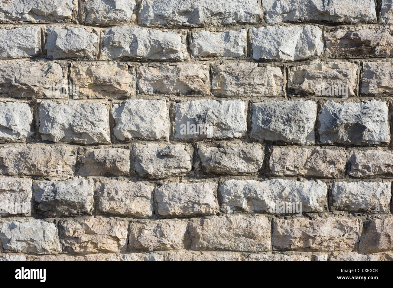 A masonry stone or brick wall background Stock Photo - Alamy