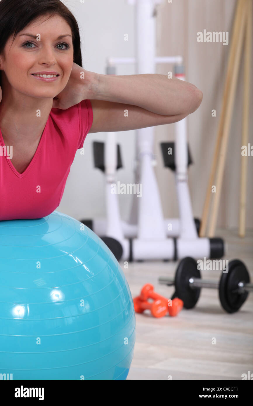 Woman using a gym ball Stock Photo - Alamy