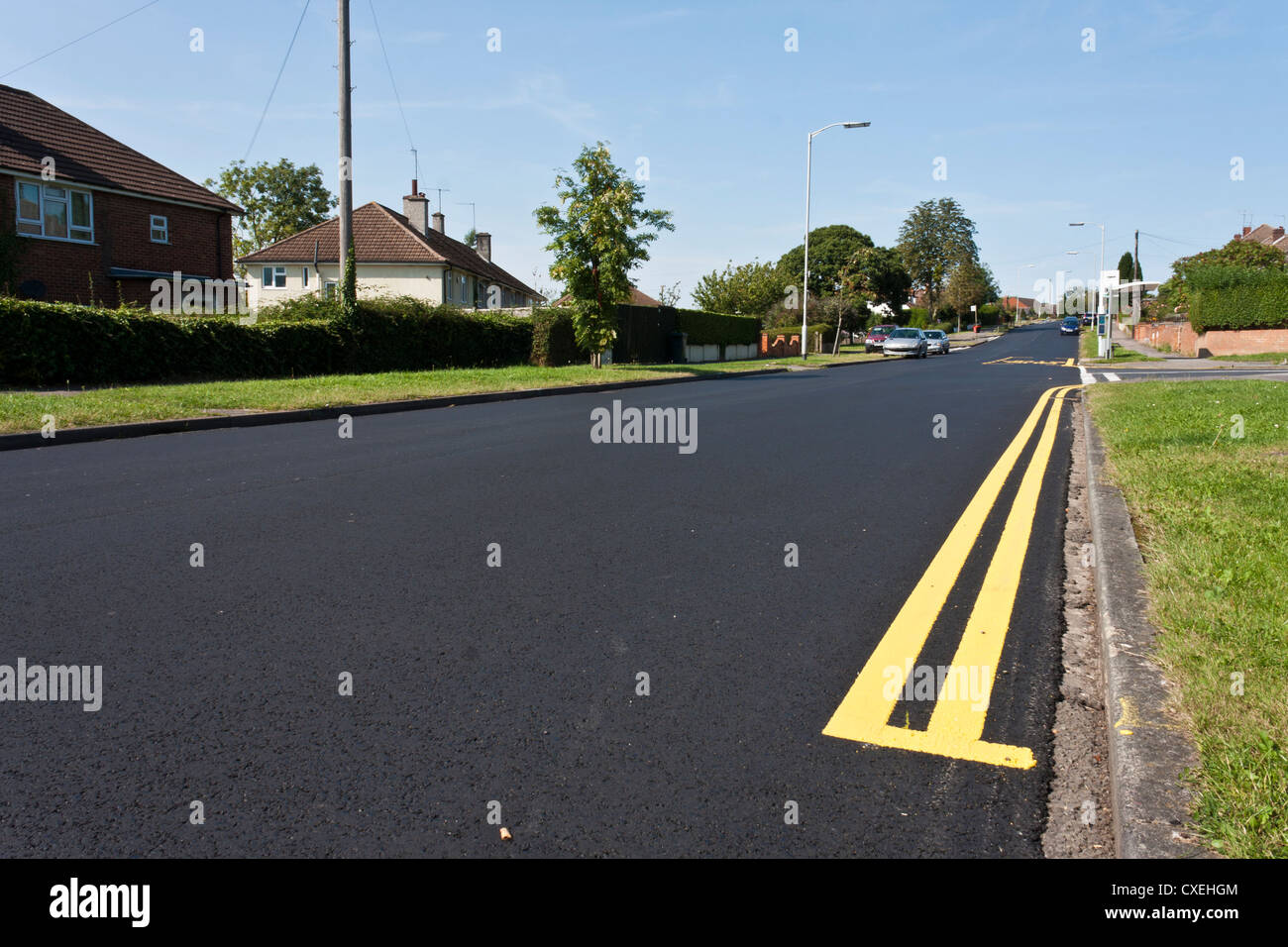 Newly painted lines on a freshly tarmacked road Stock Photo - Alamy