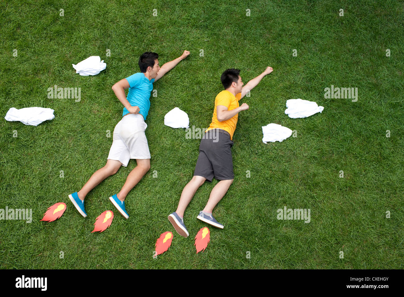 Creative young man imitating flying on meadow Stock Photo - Alamy