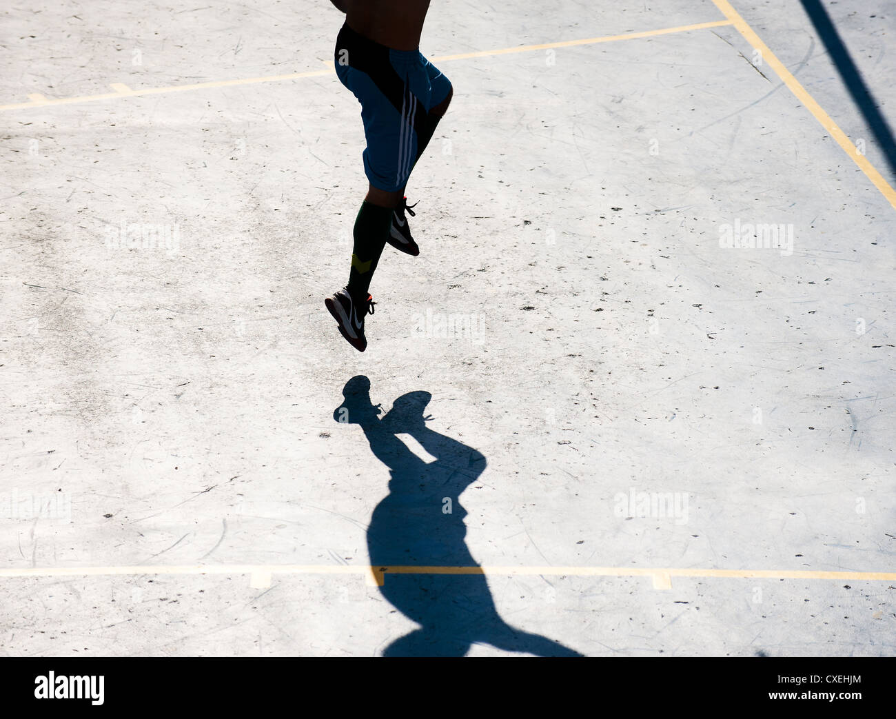 A person jumping and casting a shadow Stock Photo - Alamy