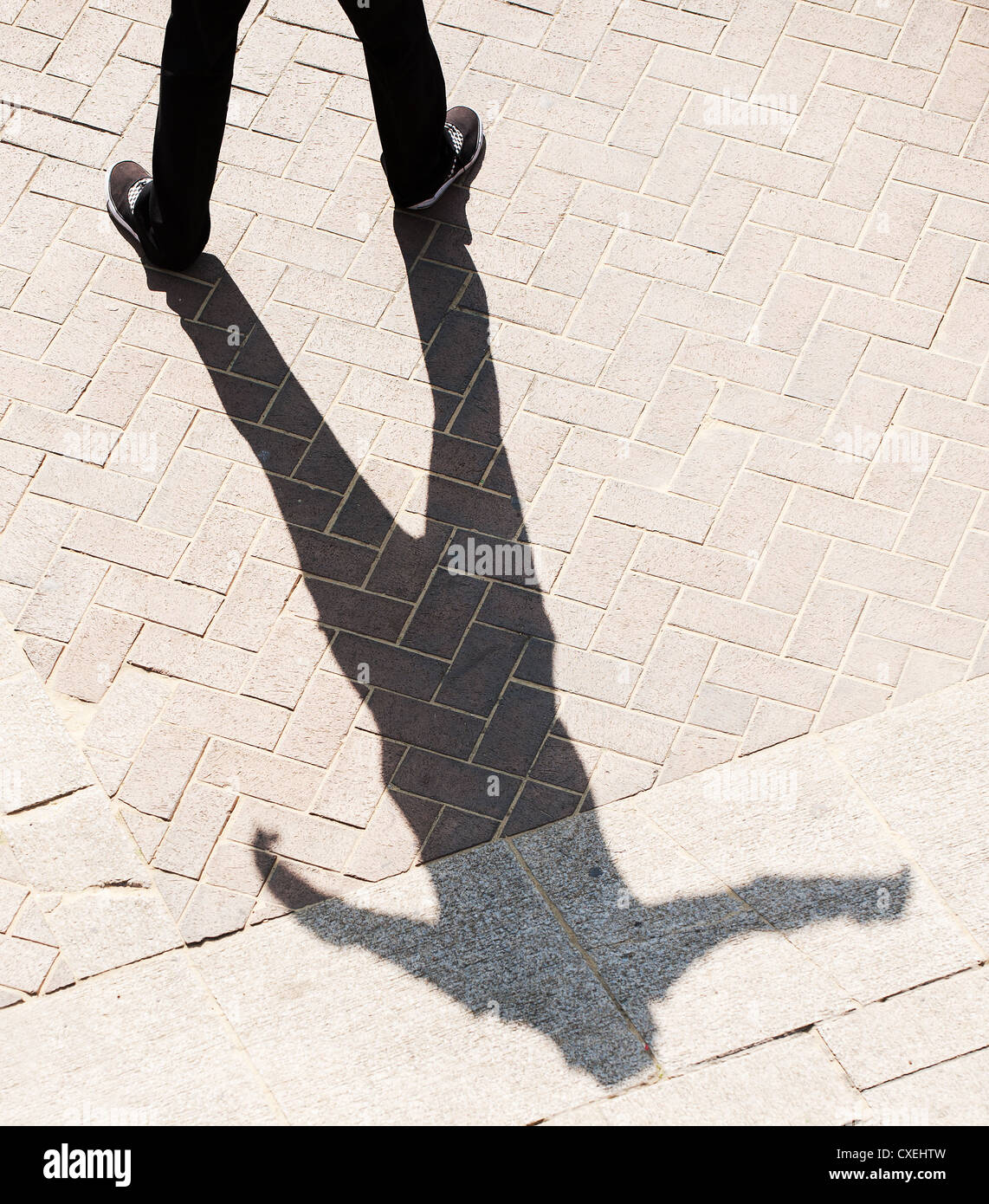 A person casting a shadow on the ground Stock Photo - Alamy