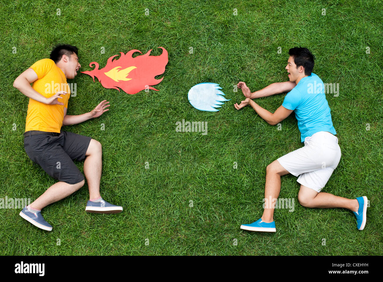 Creative young man imitating fighting on meadow Stock Photo - Alamy
