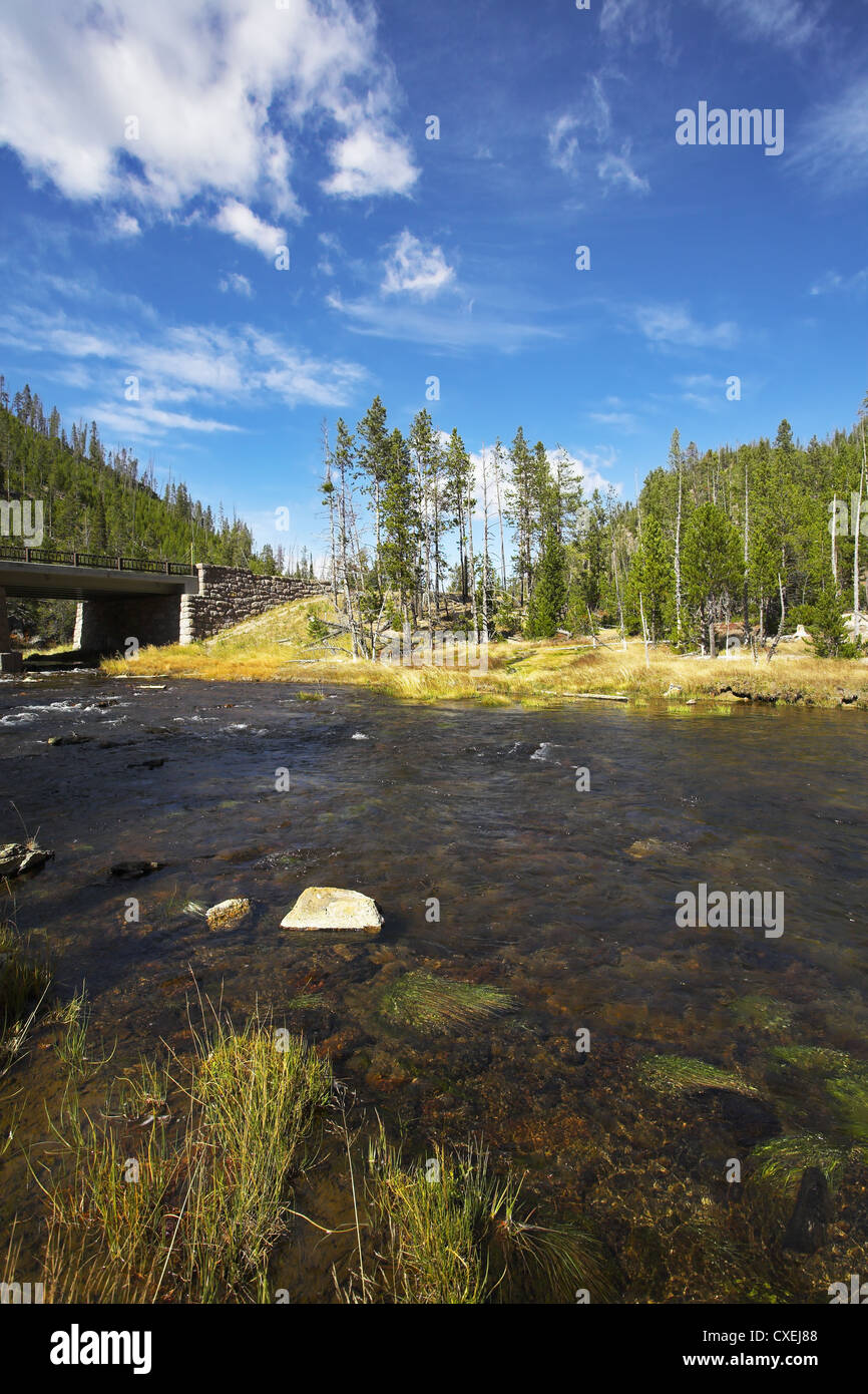 The bridge through the multi-coloured river Stock Photo - Alamy