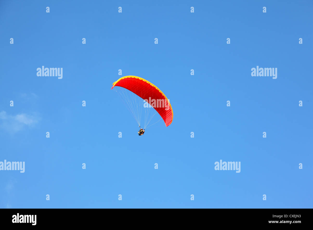 The operated red parachute flies in high Stock Photo - Alamy