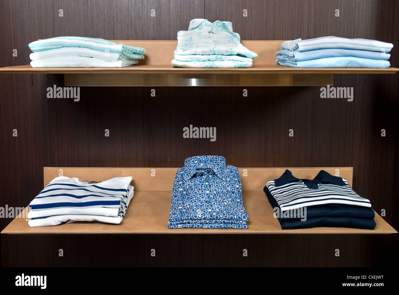wooden store shelf with color clothes Stock Photo - Alamy