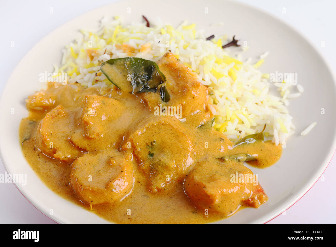 A prawn korma curry served with pilau rice Stock Photo - Alamy