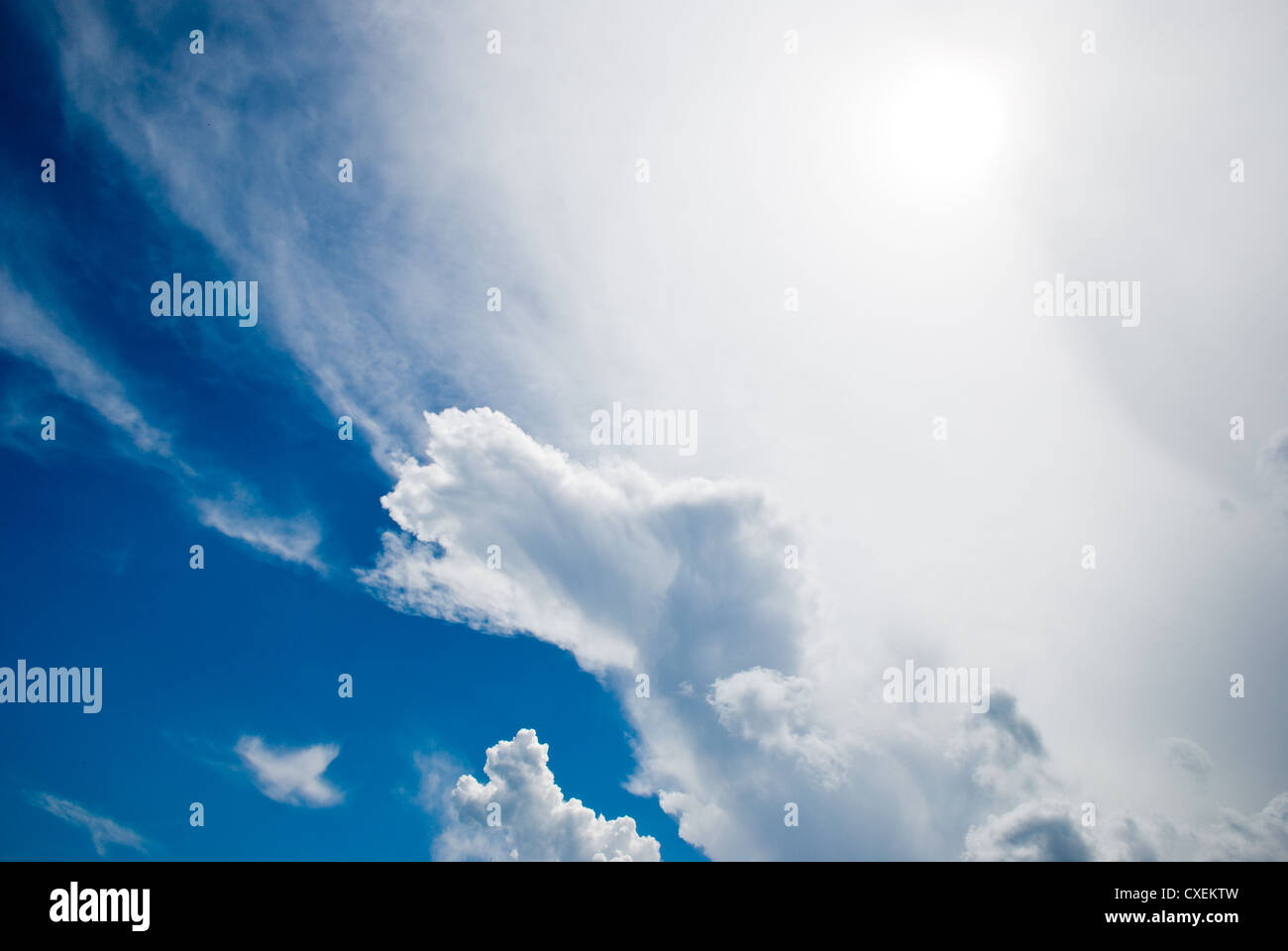 Cloudy sky with sun Stock Photo - Alamy