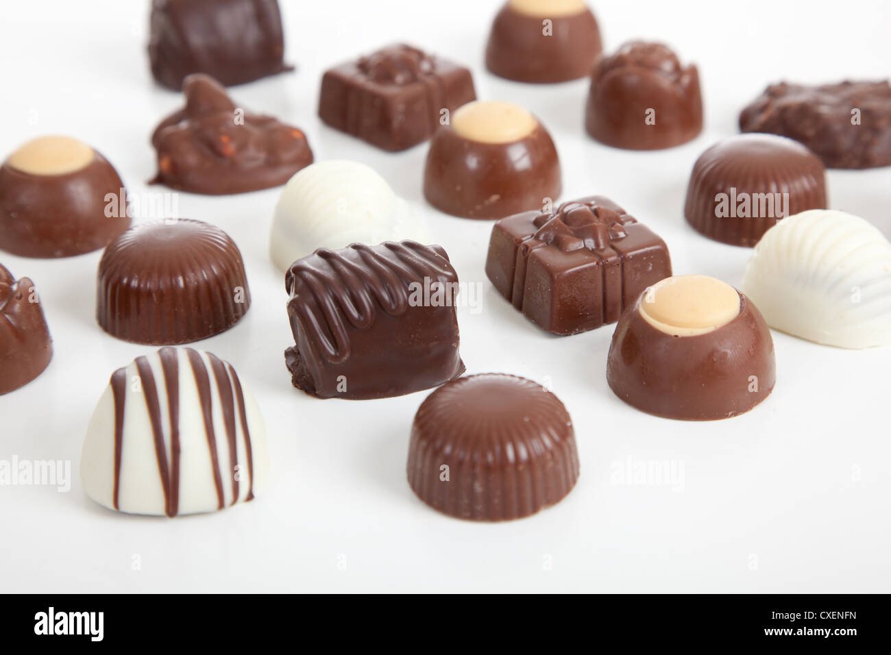 Assorted filled chocolate candies on a white background Stock Photo - Alamy