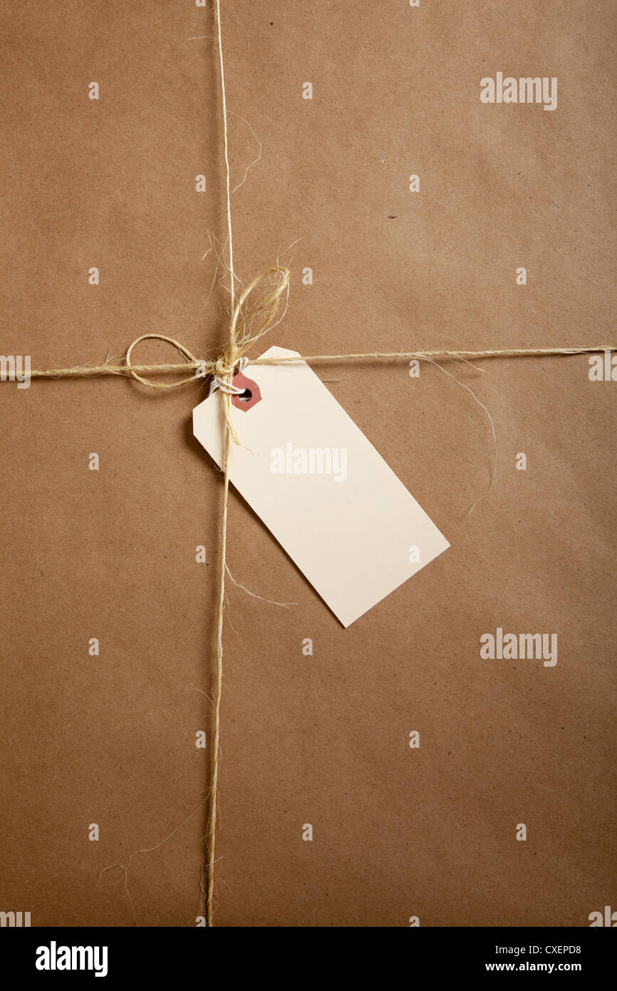 A brown craft paper background with twine and a mailing label with copy ...