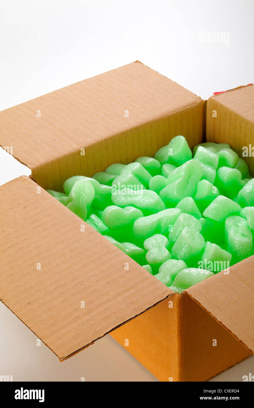 A cardboard box with green packing styrofoam peanuts Stock Photo - Alamy