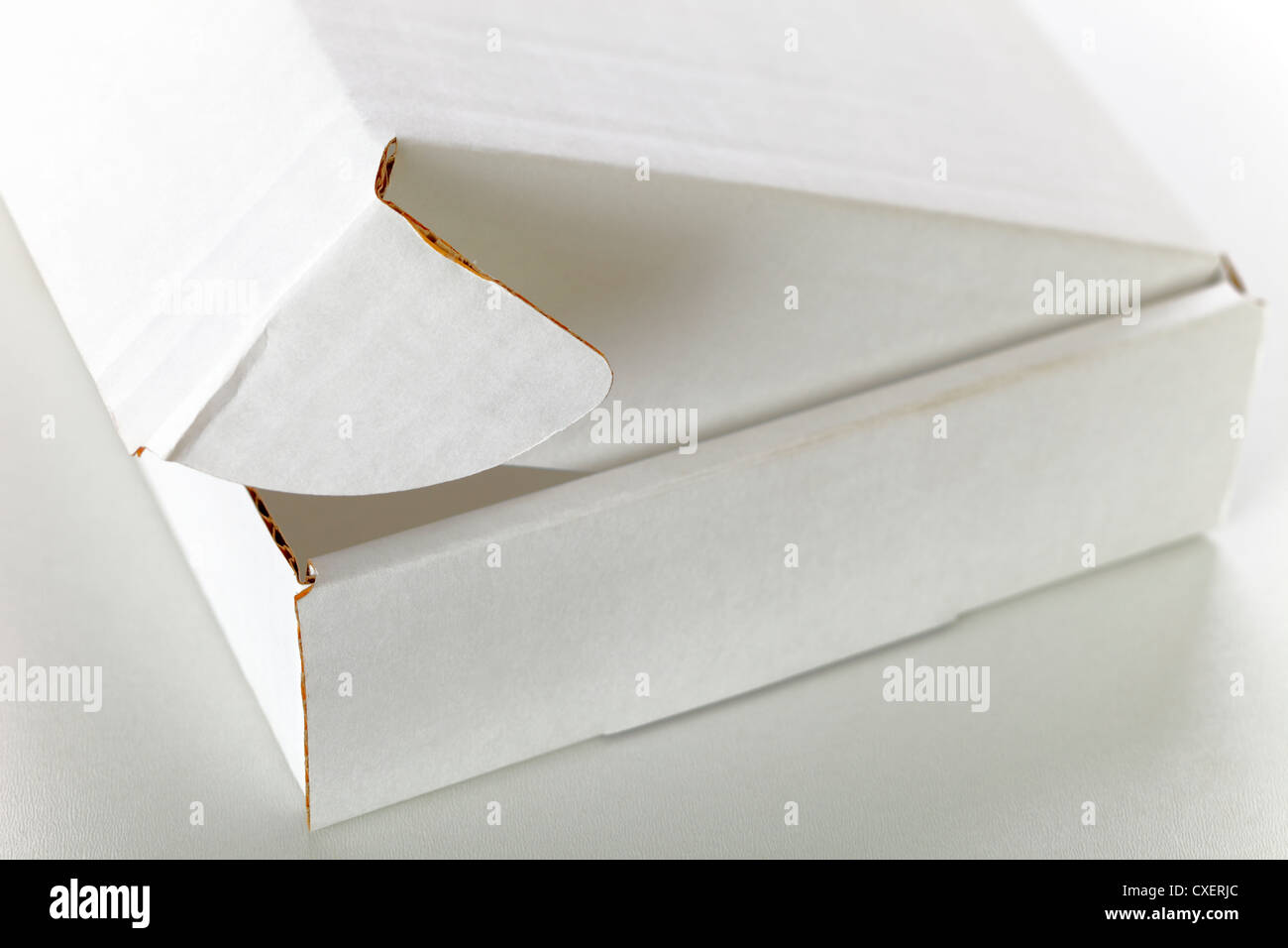 A open white cardboard box isolated on grey background Stock Photo - Alamy