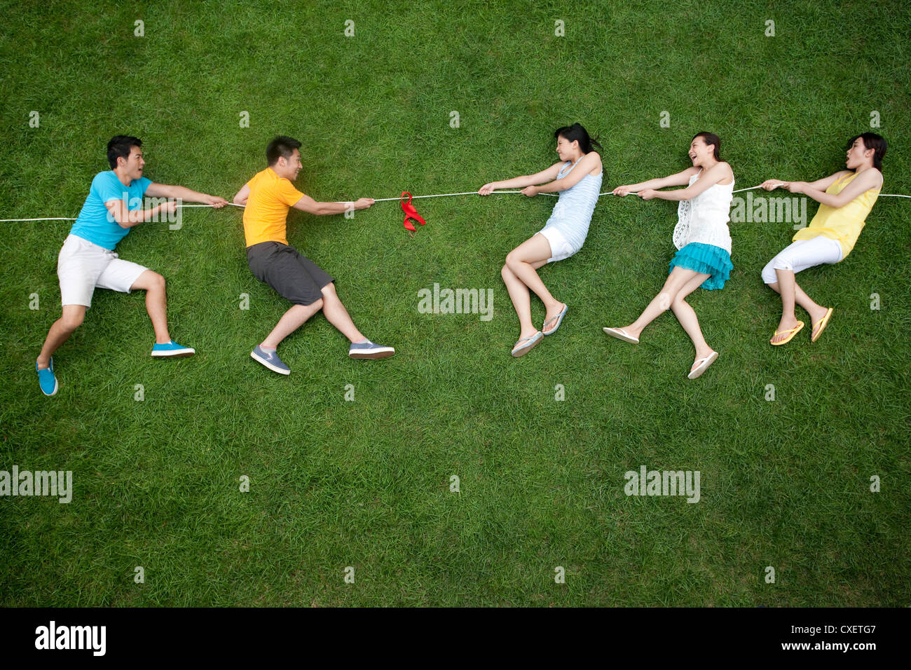 Young women playing tug of war hi-res stock photography and images - Alamy
